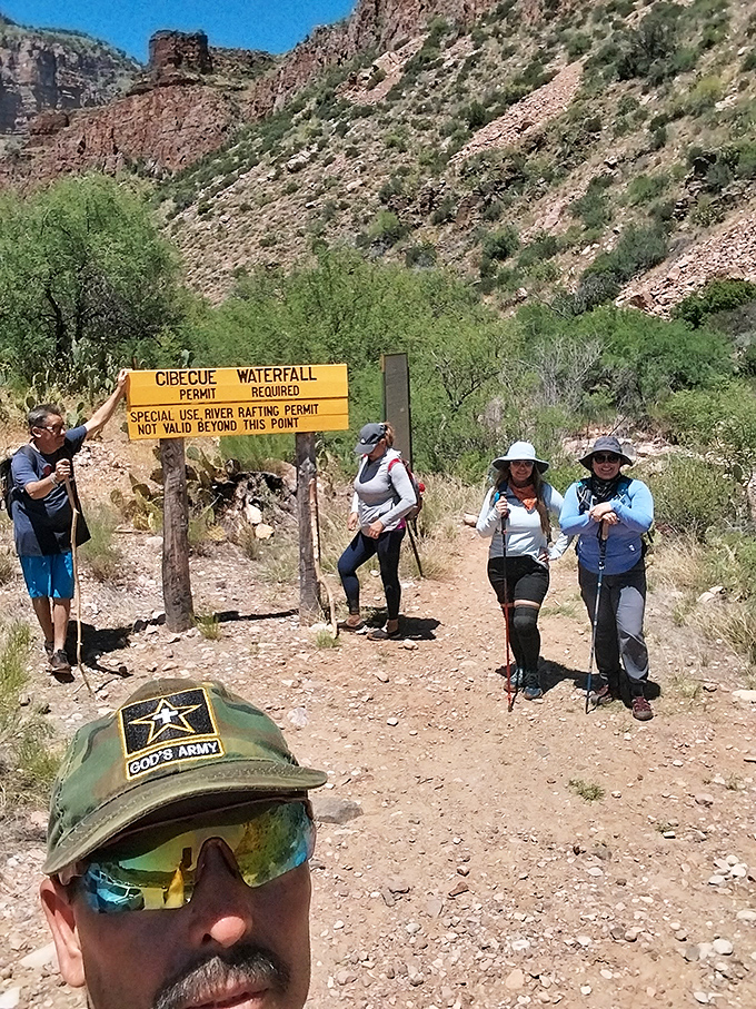 Adventurers pause at the trail sign, gathering strength for the journey ahead, those smiles will be even bigger on the return trip!