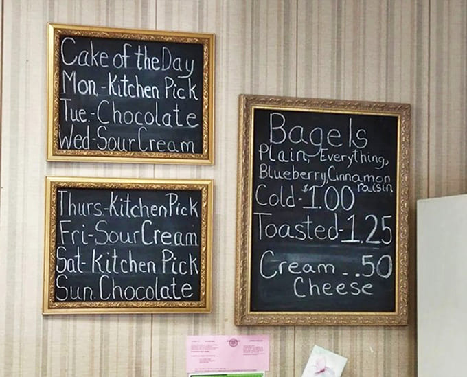 Handwritten menu boards announce daily specials with gold-framed charm &ndash; Monday's "Kitchen Pick" might just become the highlight of your week.