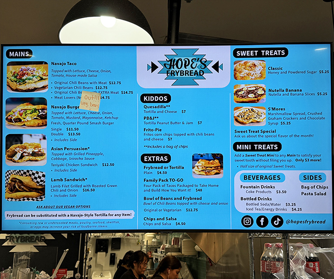 Decisions, decisions! The vibrant menu board showcases everything from classic Navajo tacos to sweet treats that'll make your sweet tooth stand at attention.