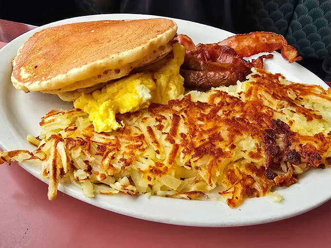 The holy trinity of breakfast bliss&mdash;golden pancakes, perfectly scrambled eggs, and bacon that's achieved that mythical balance between crisp and chewy.