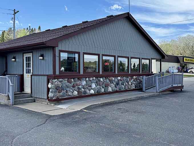 Visit this friendly local building in Iron River, featuring a unique stone foundation and a welcoming entrance for all guests.