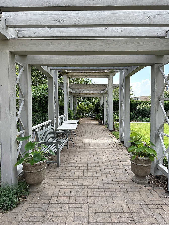 This white pergola walkway isn't just a path&mdash;it's a journey between garden rooms, each with its own personality.