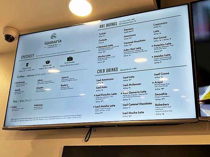 The menu board showcases an intriguing array of Yemeni coffee traditions alongside contemporary favorites, each promising its own unique flavor journey.