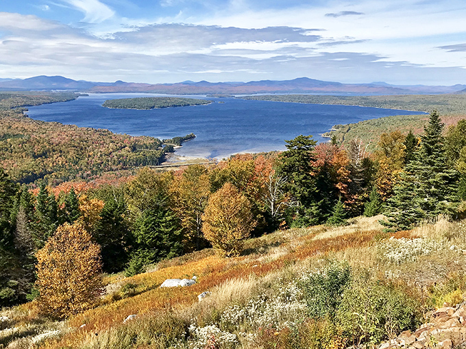 Rangeley Lake stretches toward distant mountains, creating the kind of view that makes smartphone cameras seem woefully inadequate.