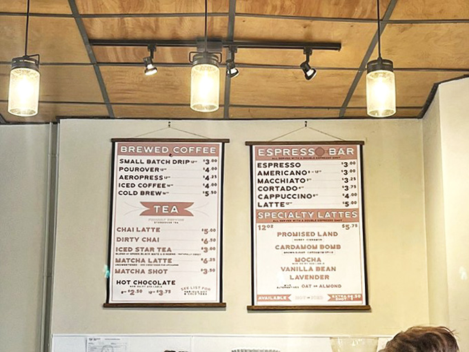 Simple canvas menus hang like coffee manifestos, promising liquid treasures from pour-overs to specialty lattes. Coffee options for both novices and aficionados.