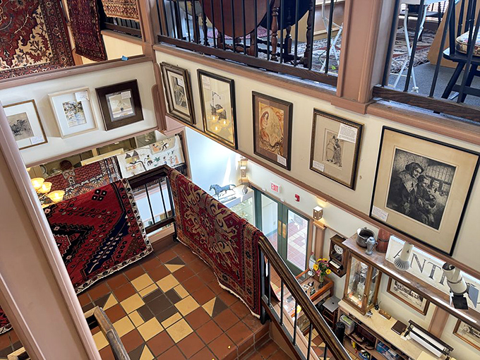 Oriental rugs cascade from balconies like colorful waterfalls of history, creating a multi-level tapestry that guides visitors through centuries of craftsmanship.