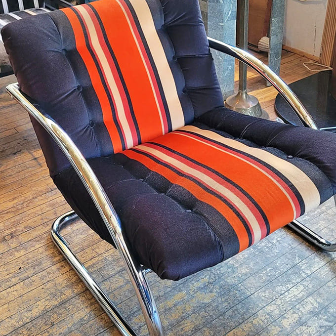 This striped lounger screams 1970s sophistication, perfect for contemplating life's mysteries or just looking incredibly stylish while napping.