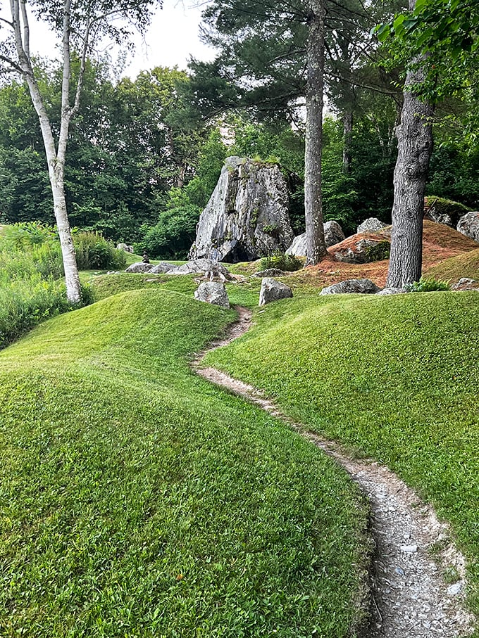 Nature's perfect pathway meanders through manicured grass, inviting visitors to follow its gentle curve toward adventures unknown.