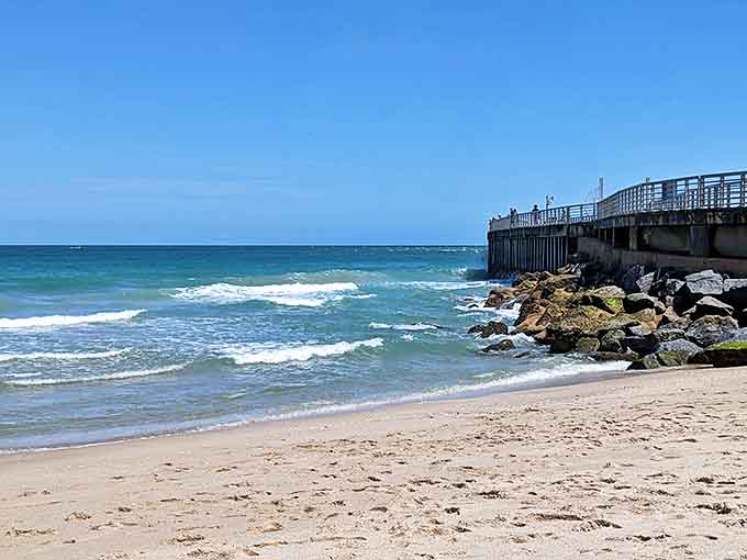 Gentle waves kiss the shoreline as beachgoers dot the sand, creating a perfect postcard of Florida coastal life.