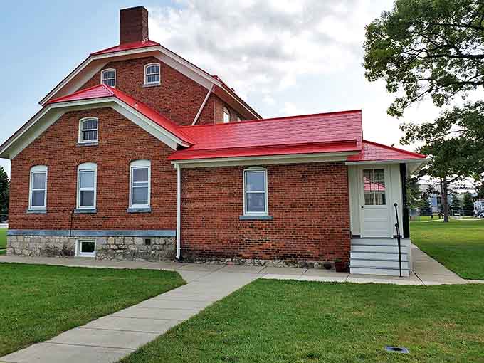 The keeper's quarters, built of sturdy brick with a distinctive red roof, housed generations of lighthouse keepers who maintained this vital navigational aid.