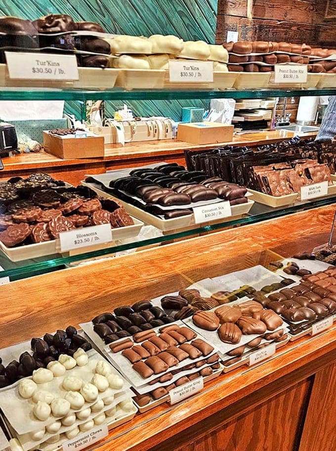 Chocolate paradise awaits behind gleaming glass cases &ndash; rows of handcrafted truffles, creams, and caramels arranged like edible jewels, each promising a moment of pure bliss.