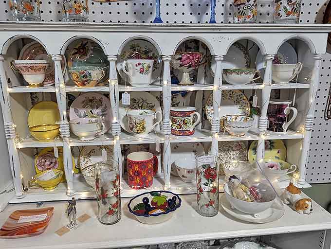 Delicate teacups and saucers wait patiently for their next afternoon tea, each pattern whispering tales of elegant gatherings from decades past.