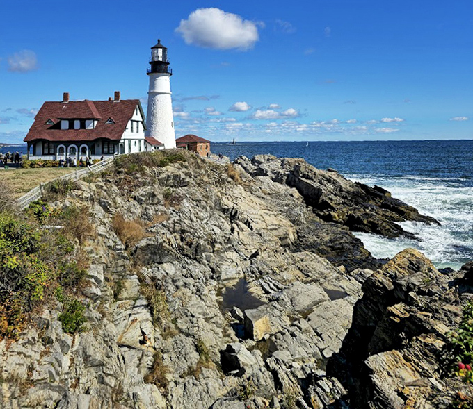Perched dramatically on rugged cliffs, Portland Head Light seems to grow naturally from the rocky Maine coastline it's protected for centuries.