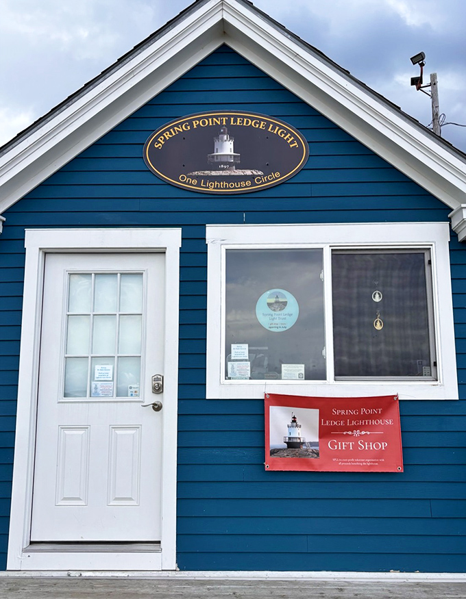 The charming blue gift shop building welcomes visitors with maritime treasures and local knowledge about the historic lighthouse.