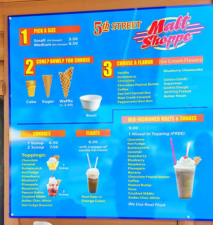 Menu: Decision paralysis strikes as the vibrant blue menu board tempts with possibilities—from classic vanilla to exotic Blueberry Cheesecake creations.