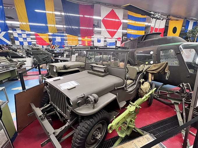 Step inside to a wonderland of military vehicles, where colorful naval flags create a striking contrast against the serious machinery below.
