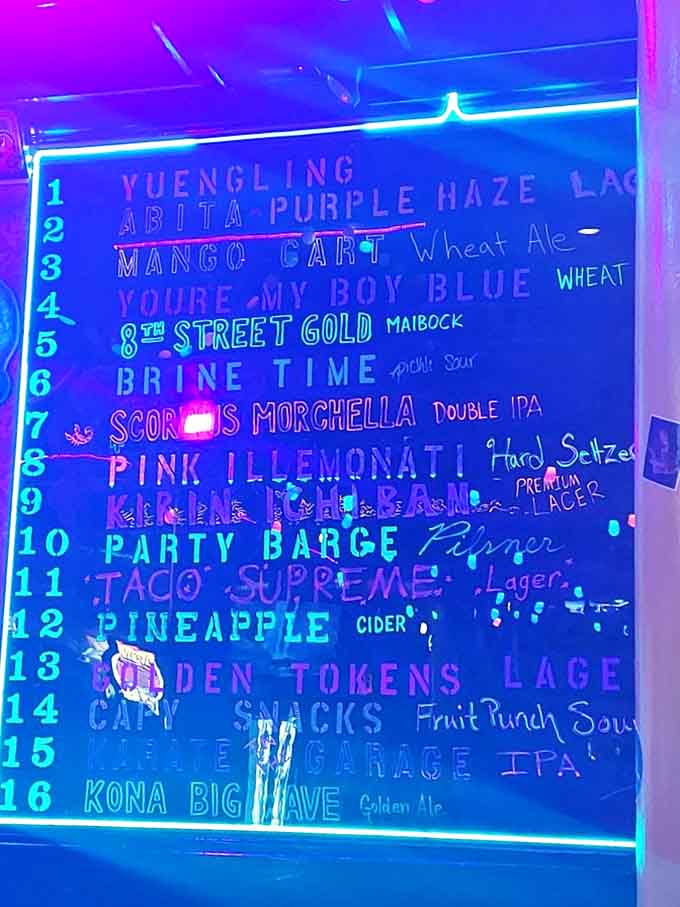 The illuminated beer board glows like a high score screen, featuring local brews and craft favorites that pair perfectly with gaming sessions.