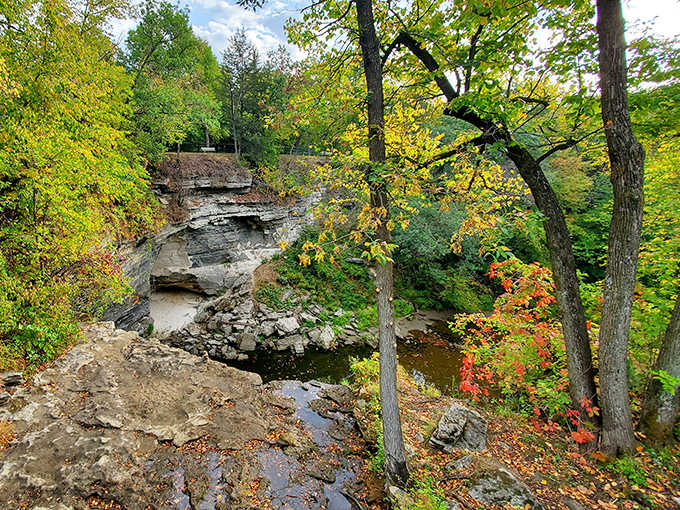 Limestone cliffs frame the waterway like natural architecture, showcasing millions of years of Earth's patient craftsmanship.