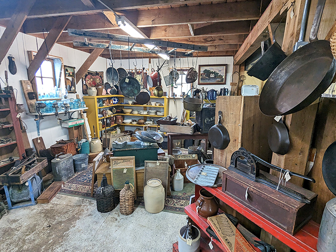 Kitchen artifacts from yesteryear hang in suspended animation, each cast iron pan and copper pot whispering stories of family meals long past.