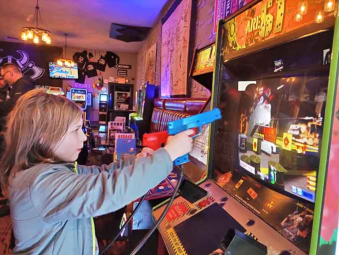 Young warriors test their skills at vibrant arcade cabinets, proving video game passion transcends generations in this digital playground.