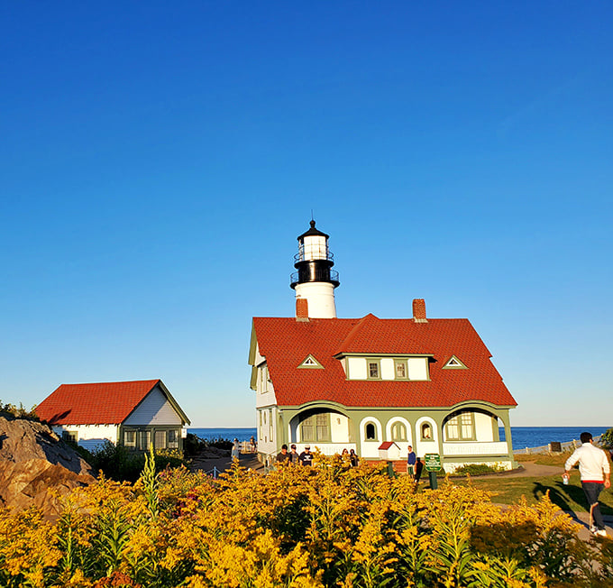 Visitors stroll the grounds of Fort Williams Park, where history and natural beauty converge in one of New England's most breathtaking settings.