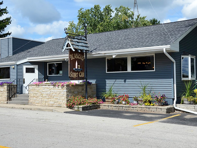Blanck's Supper Club's cheerful blue exterior and flower displays create an instantly welcoming first impression that matches the warmth inside.
