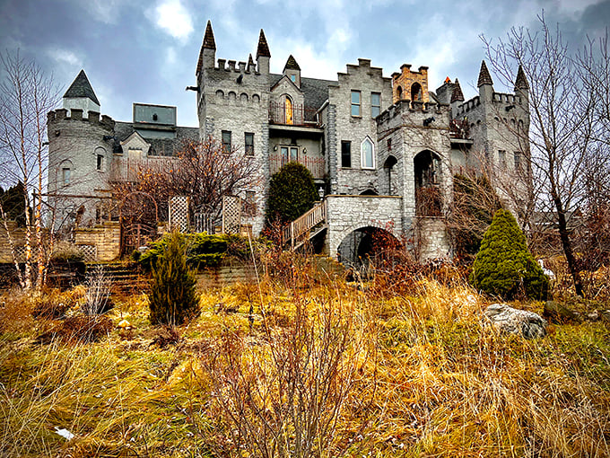 RavenStone Castle emerges from the landscape like a medieval dream, its weathered stone walls and multiple turrets creating a hauntingly beautiful silhouette against the moody sky.