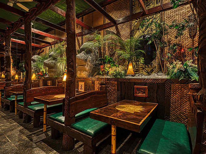 The Tiki Terrace transports you to a Polynesian paradise with its bamboo decor, carved masks, and tropical ambiance that makes Illinois disappear.