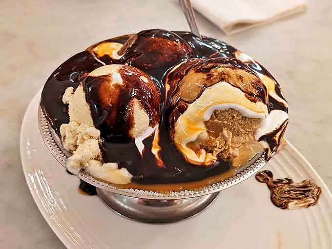 This isn't just any sundae &ndash; it's an architectural marvel of ice cream, hot fudge, and caramel that makes calories worth every delicious bite.