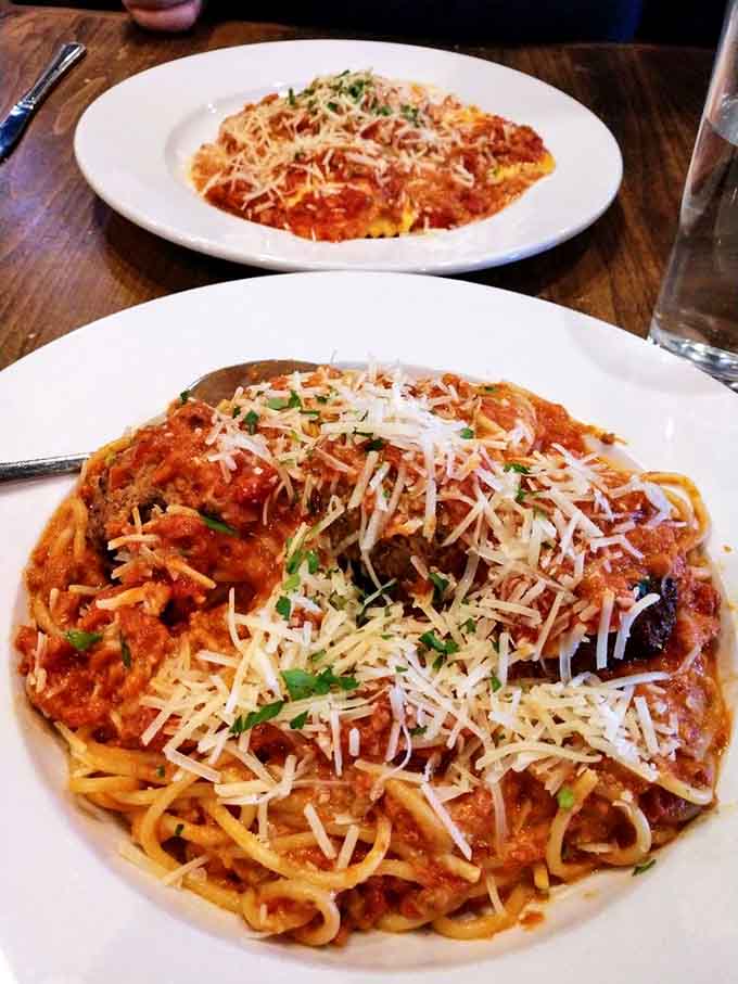 Spaghetti and meatballs piled high with cheese, proving that some classics never need improvement, just proper execution.