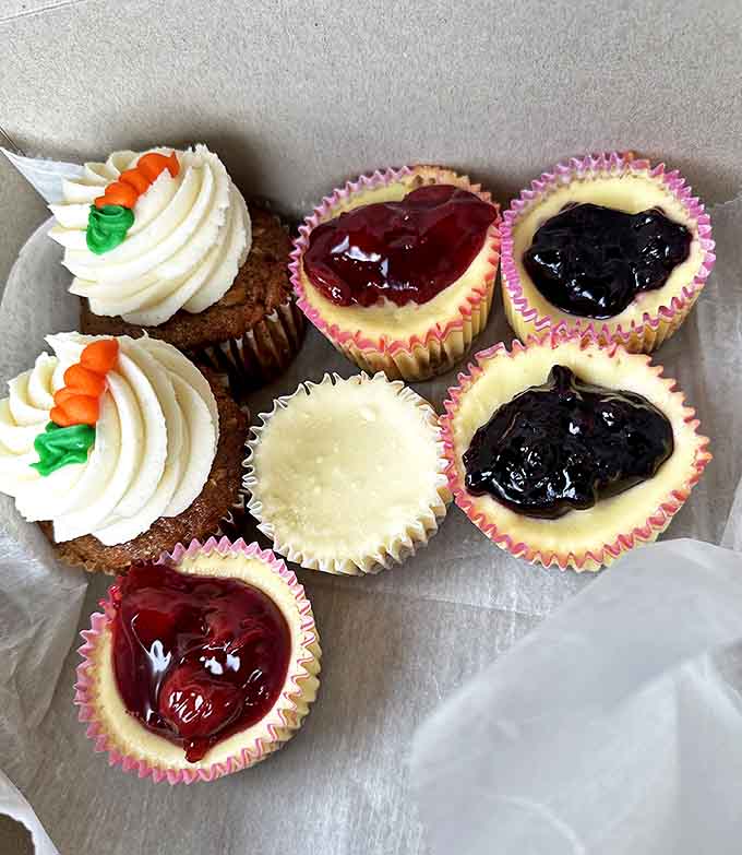 These aren't just cupcakes; they're edible joy. Carrot cake topped with tiny carrots and cheesecake varieties with fruit compote create impossible decisions.