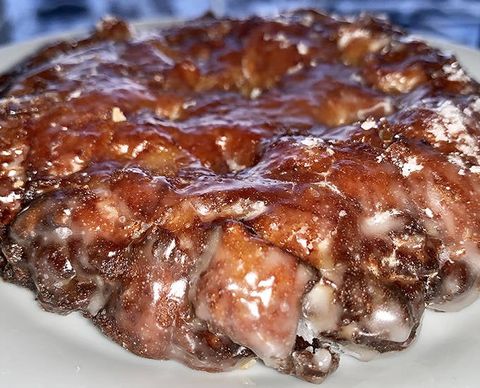 Close encounters of the fritter kind &ndash; where caramelized edges meet tender, apple-studded interior in perfect harmony.