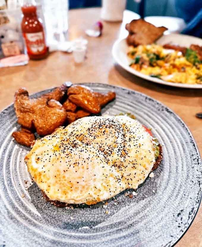 Perfectly fried eggs crown crispy potatoes in this hearty breakfast that proves simple ingredients can create extraordinary mornings when done right.
