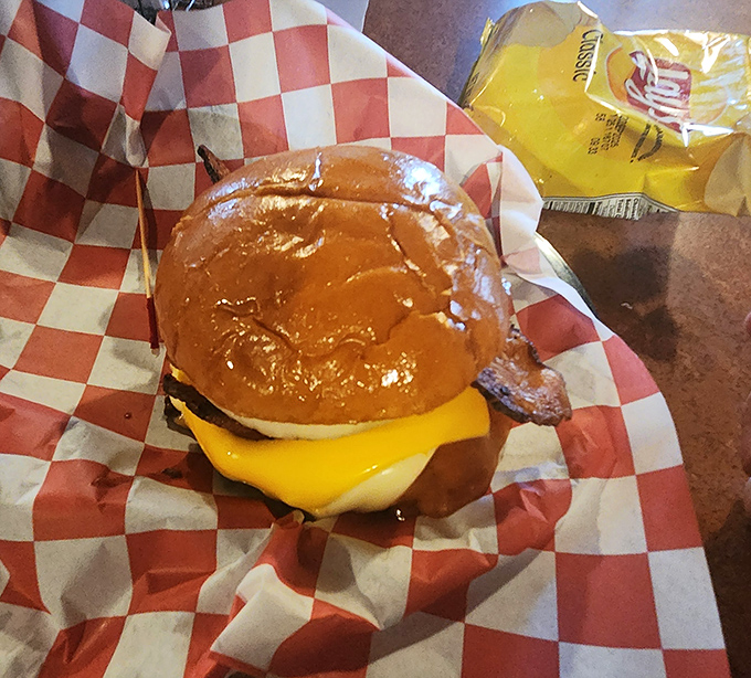 The bacon cheeseburger arrives in all its glory, that perfectly melted cheese and crispy bacon creating the kind of harmony that makes you believe in a higher power.