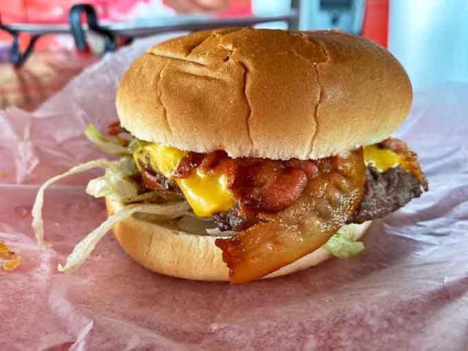 This isn't just a burger &ndash; it's edible poetry with perfectly melted cheese cascading over a juicy patty and crispy bacon.