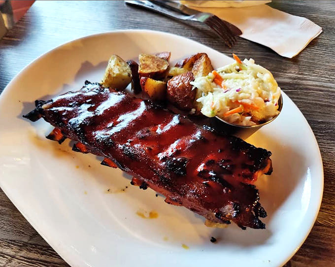 These barbecue ribs fall off the bone like they're trying to escape, glazed to sticky perfection with sides that don't disappoint.