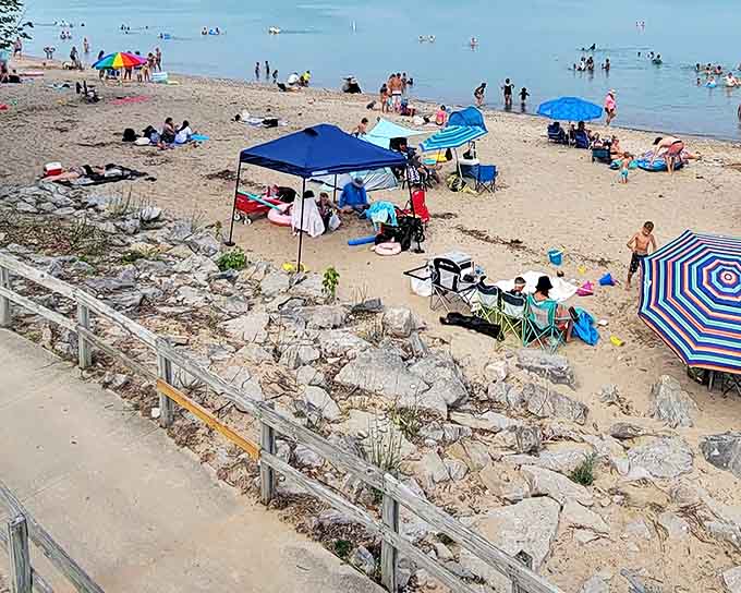 Beach day in full swing! Colorful umbrellas dot the shoreline as visitors claim their spots on Lakeport's sandy stretch of paradise.