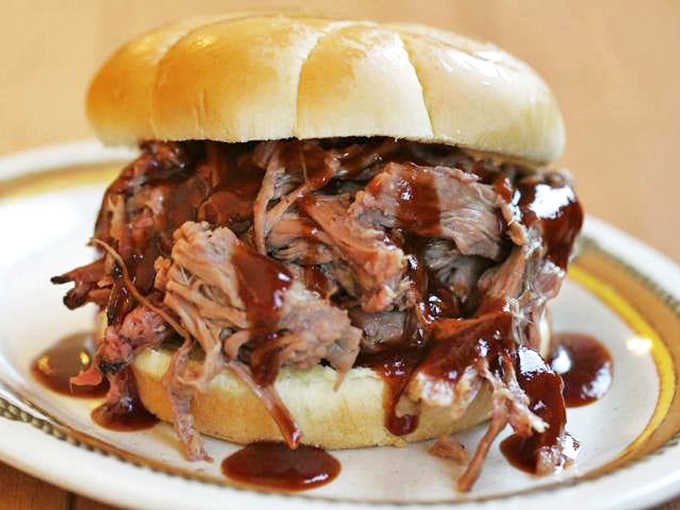 The crown jewel of Hickory River &ndash; tender, smoky brisket piled high on a soft bun with sauce dripping temptingly.