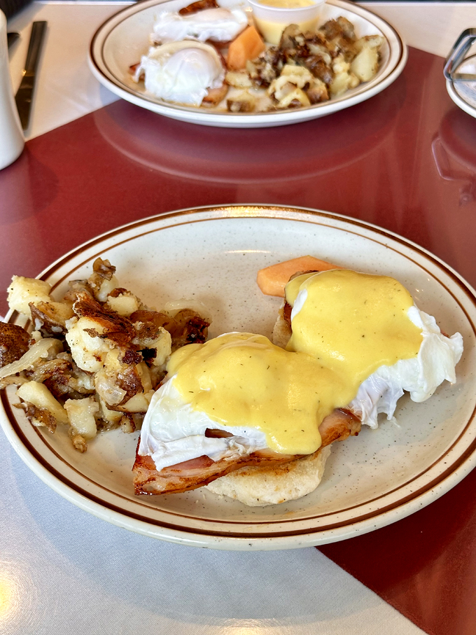 Eggs Benedict done right &ndash; hollandaise sauce cascading over Canadian bacon and poached eggs with home fries that deserve their own fan club.