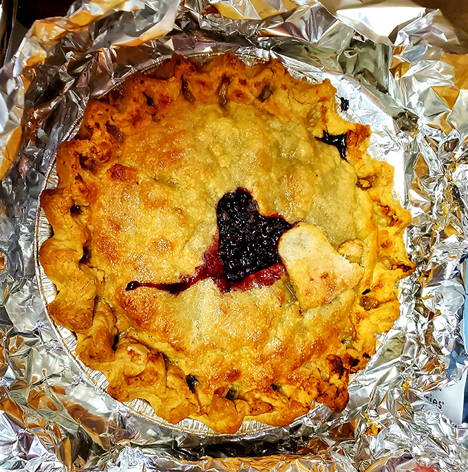 A perfect wild blueberry pie, its golden crust barely containing the deep purple filling that promises an explosion of Maine flavor.