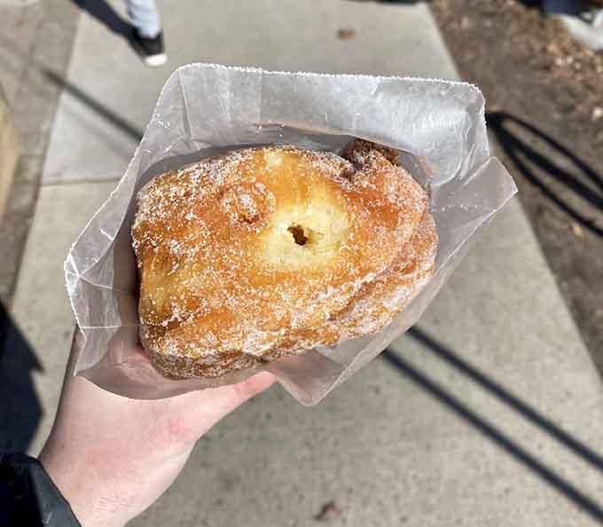 That powdered sugar coating on golden-fried perfection is what breakfast dreams are made of, folks.