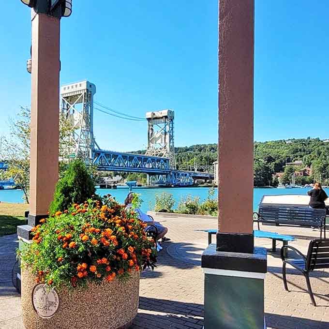 Bridgeview Park offers the perfect vantage point to admire Houghton's iconic lift bridge, framed by vibrant flowers and Lake Portage's sparkling waters.