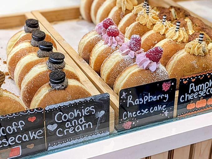 Brioche donuts lined up like edible soldiers, each one stuffed with cream and ready to make your day infinitely better than it was.
