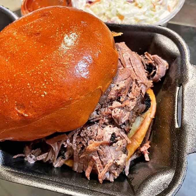 Behold the brisket sandwich in all its glory, piled high with tender smoked meat that's been treated with the respect it deserves.