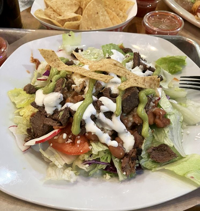 This isn't just a taco salad; it's an architectural achievement of crisp lettuce, seasoned beef, and creamy toppings that makes "eating healthy" deliciously deceptive.