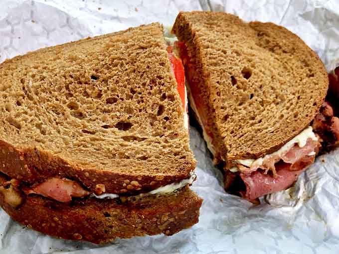 This isn't just a sandwich; it's architecture with flavor. Layers of pastrami and rye creating the skyscraper of sandwiches.