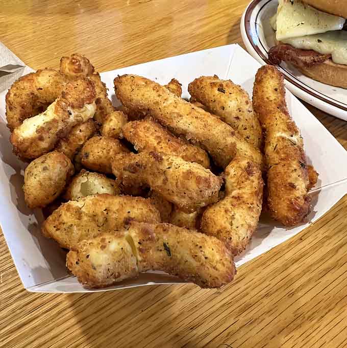 Classic cheddar cheese curds arrive golden and glistening, each one a crispy-outside, melty-inside miracle of dairy engineering.