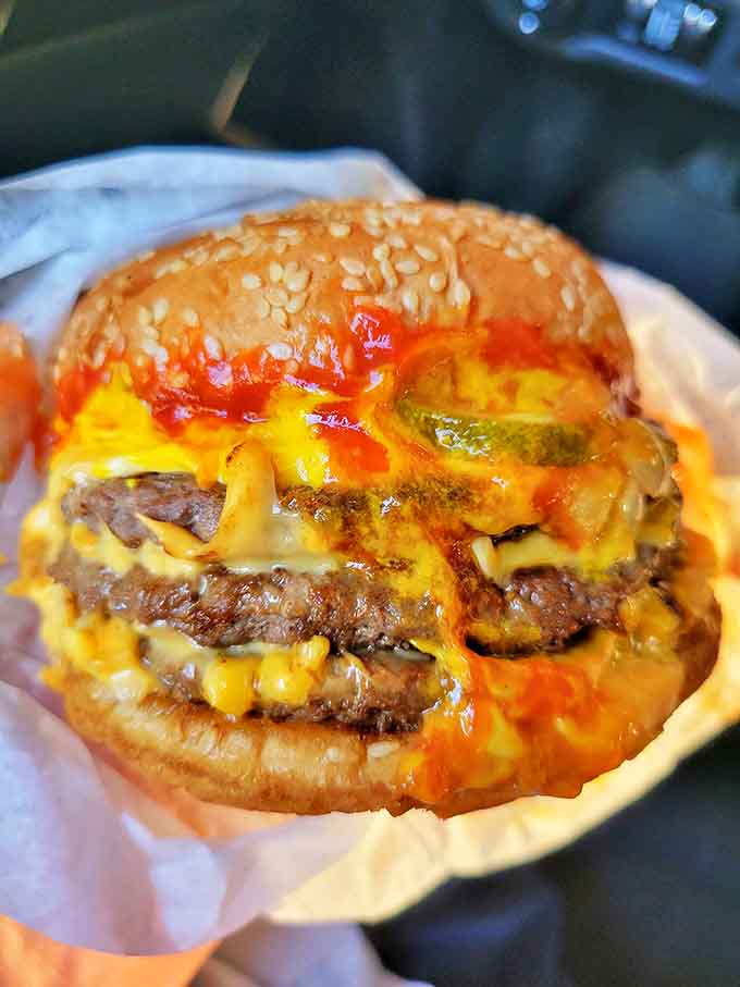 This isn't just a burger &ndash; it's a masterpiece of melted cheese cascading over beef like a yellow waterfall of deliciousness.