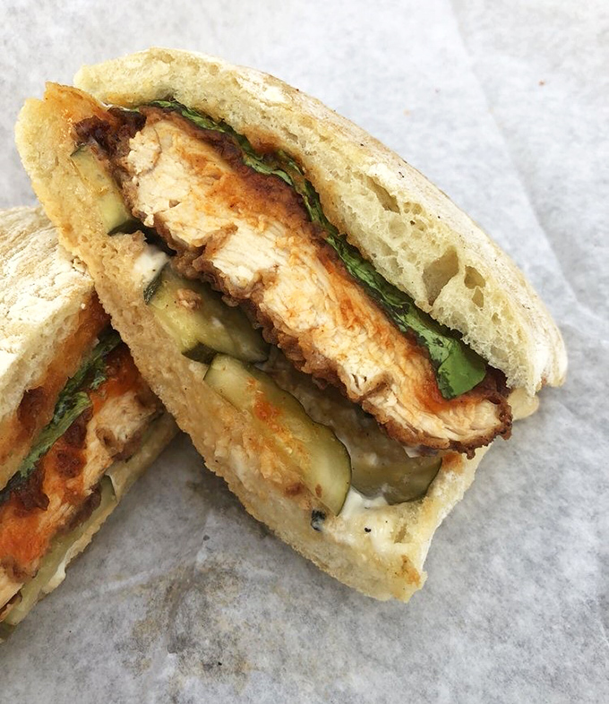 Behold the sandwich that launched a thousand return visits &ndash; crispy chicken nestled between pillowy bread with house-made pickles peeking out.