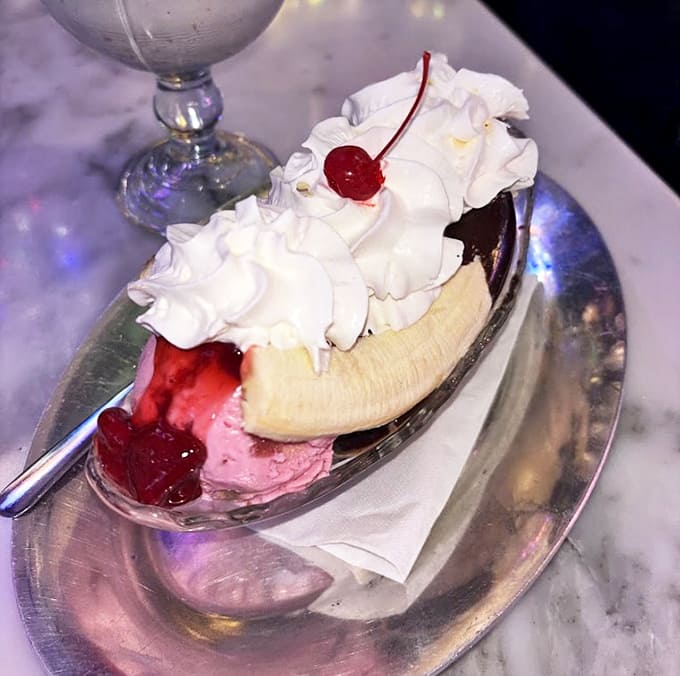 Classic elegance meets childlike indulgence &ndash; this banana split on silver serveware is dessert royalty holding court.